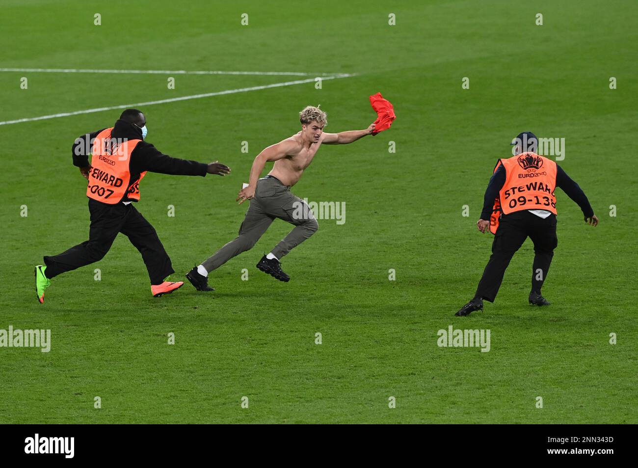 A pitch invader runs onto the field during the Euro 2020 final soccer ...