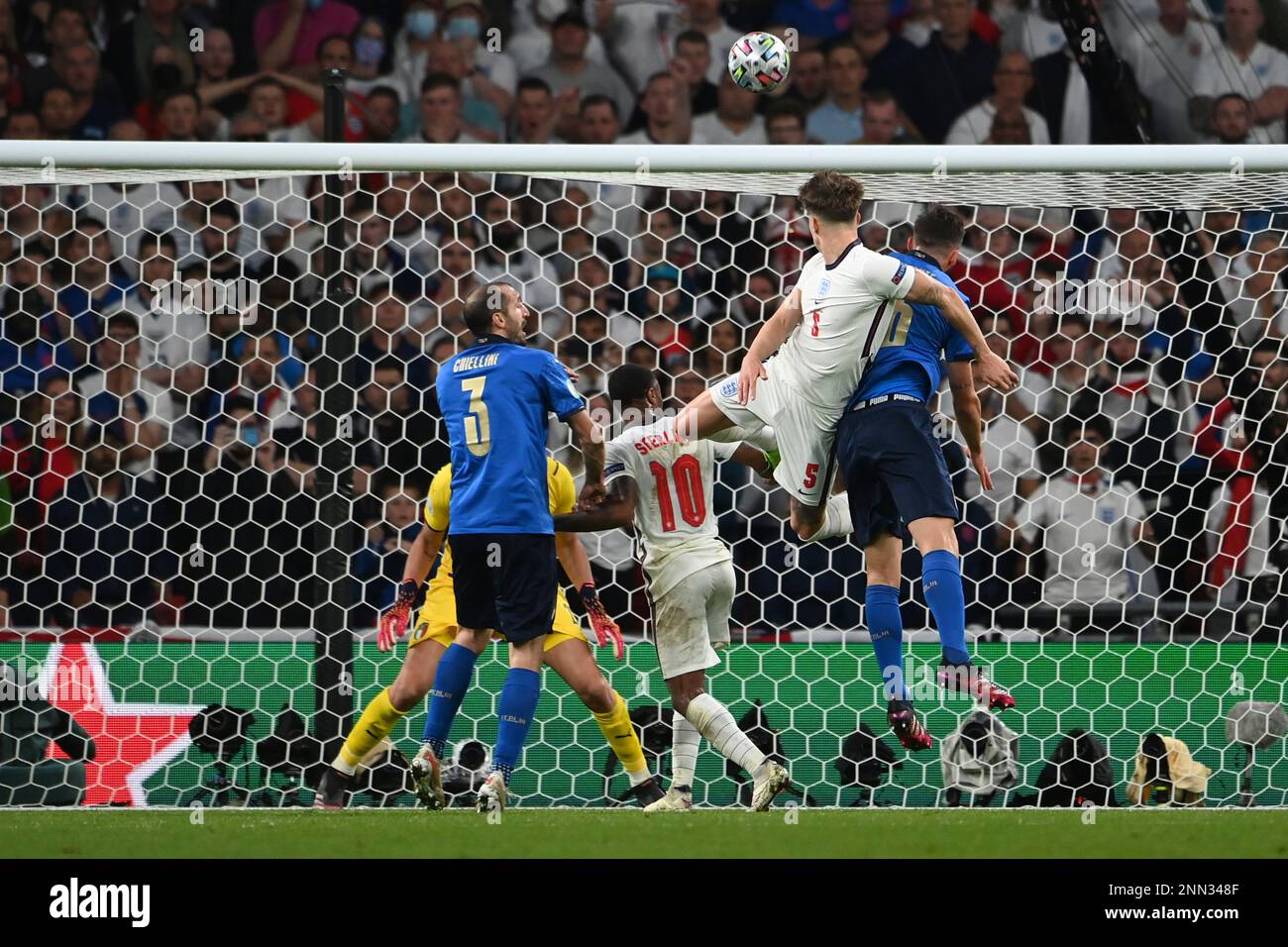 England's John Stones, second right, attempts a head at goal in front ...