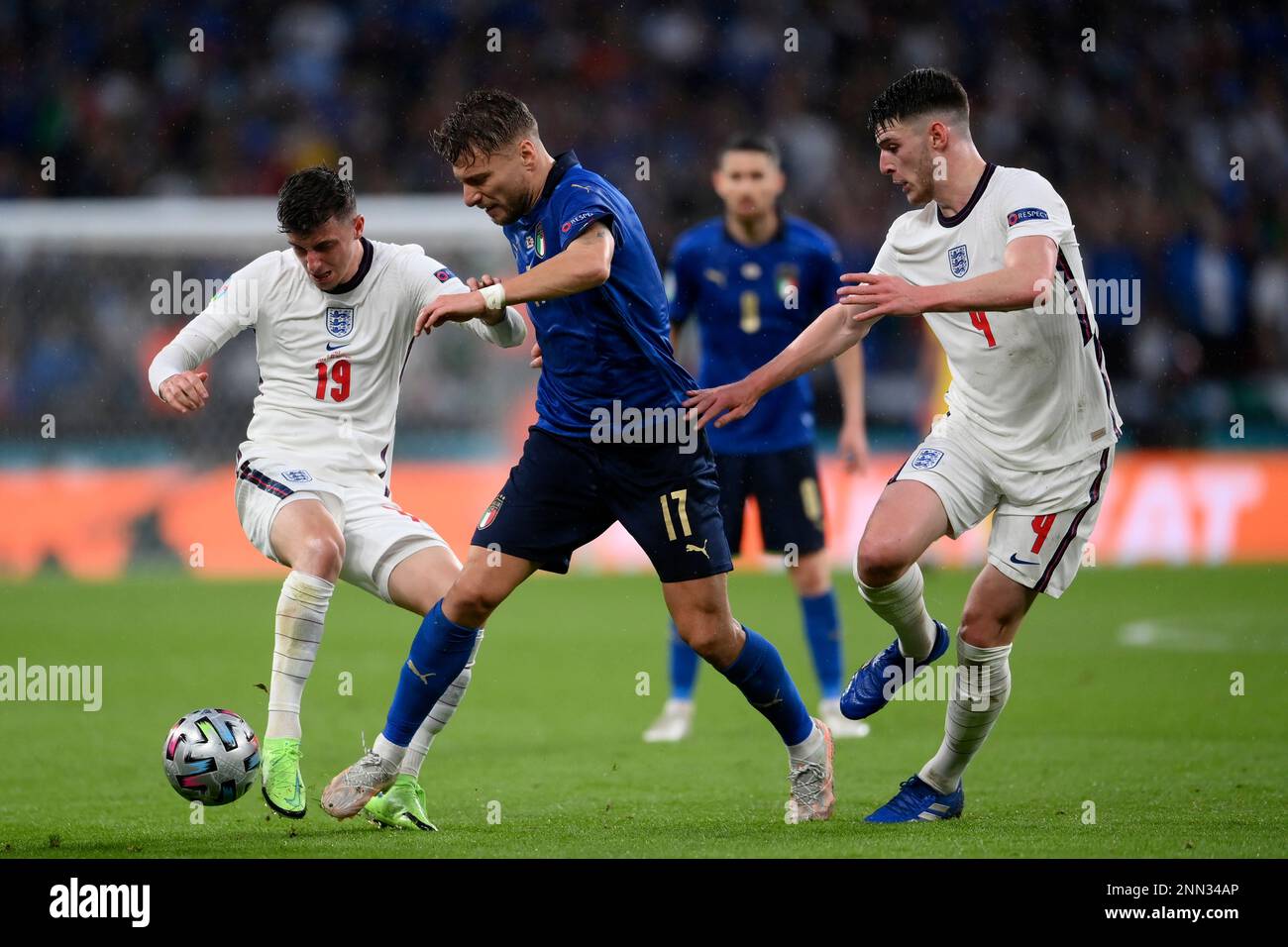 England's Mason Mount, left, and Declan Rice, right, try to stop Italy ...
