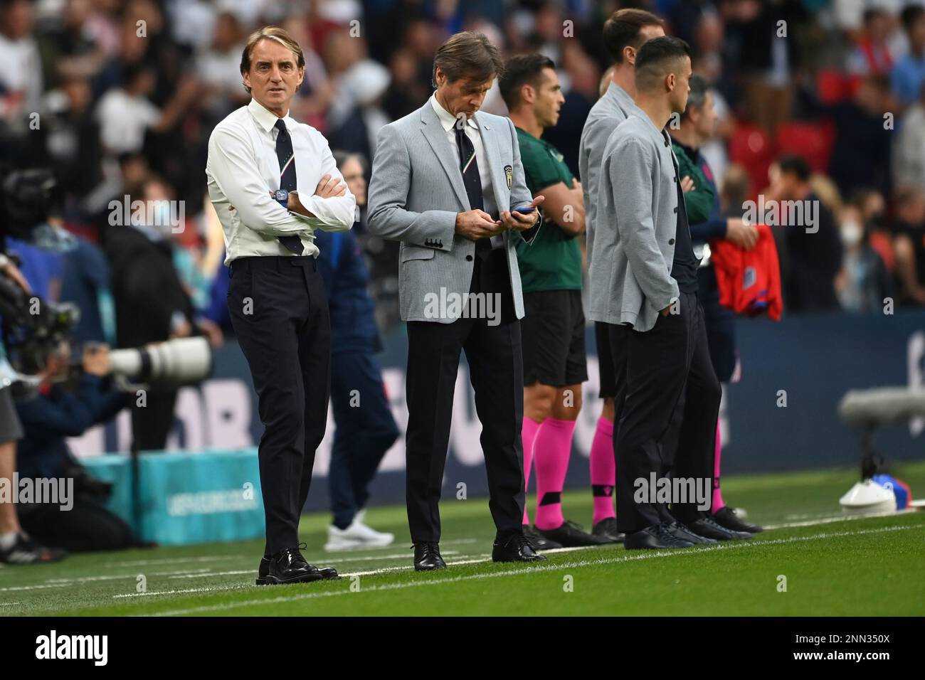Italy's manager Roberto Mancini, left, checks the field ahead of the ...