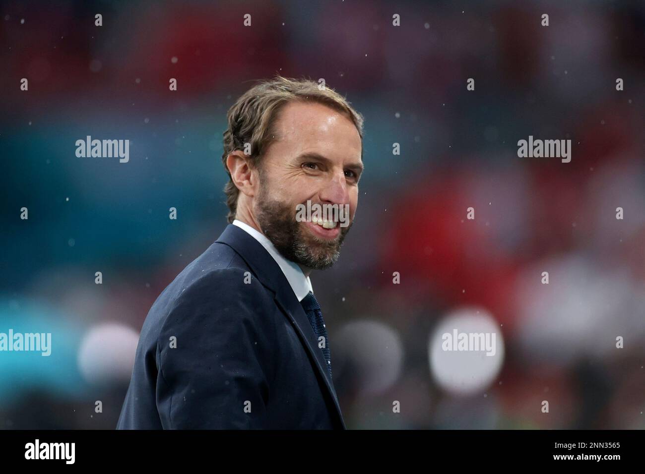 England's manager Gareth Southgate smiles as he walks on the pitch ...