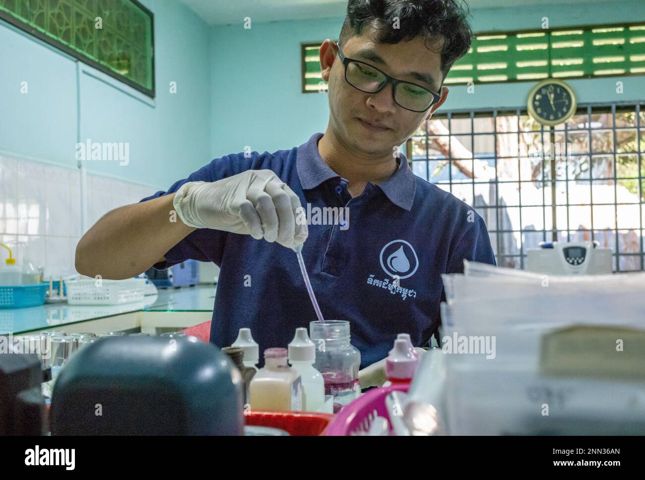 A Lab Technician Tests A Sample For Water Purity At The Offices Of