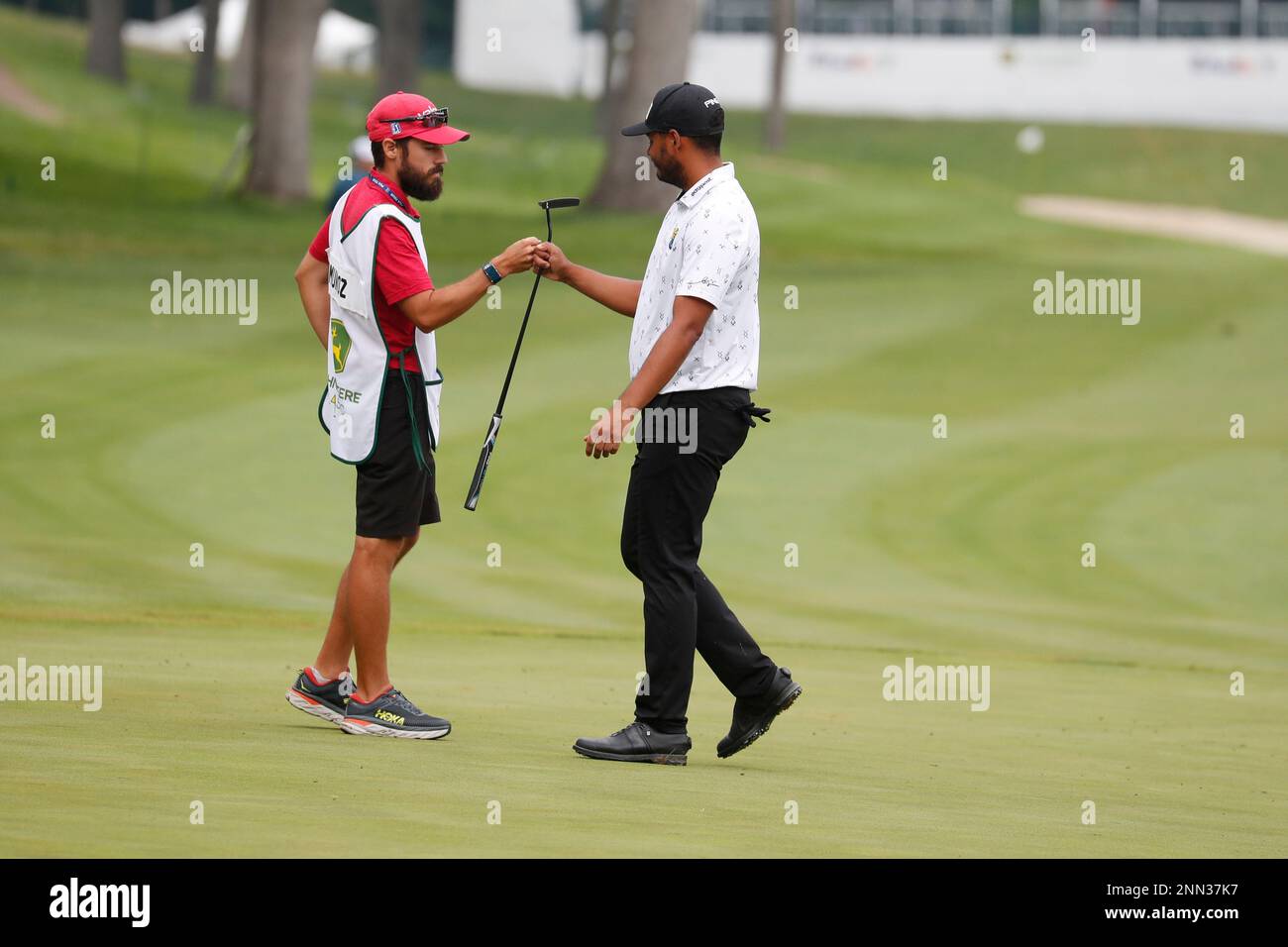 SILVIS, IL - JULY 10: PGA golfer Sebastian Munoz fist bumps his caddie ...