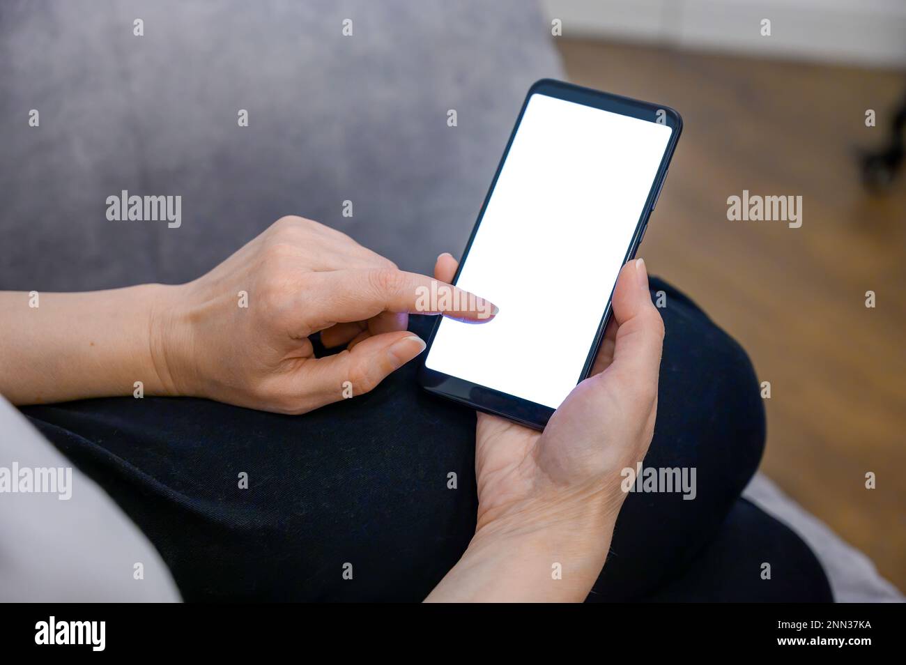 smartphone in hands. phone mockup in female hand showing white screen ...