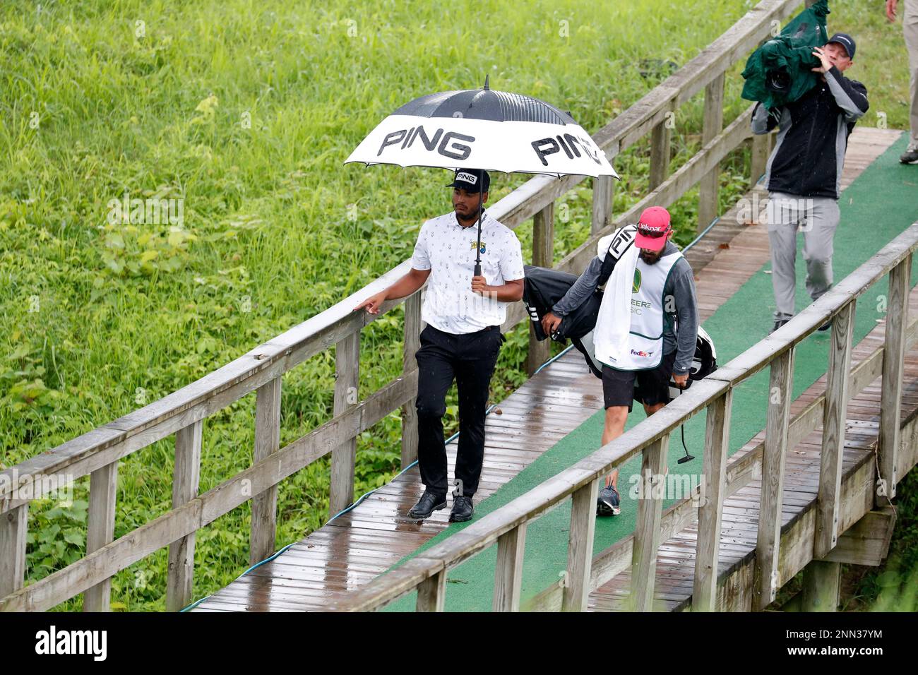 SILVIS, IL - JULY 10: PGA golfer Sebastian Munoz walks across a bridge ...