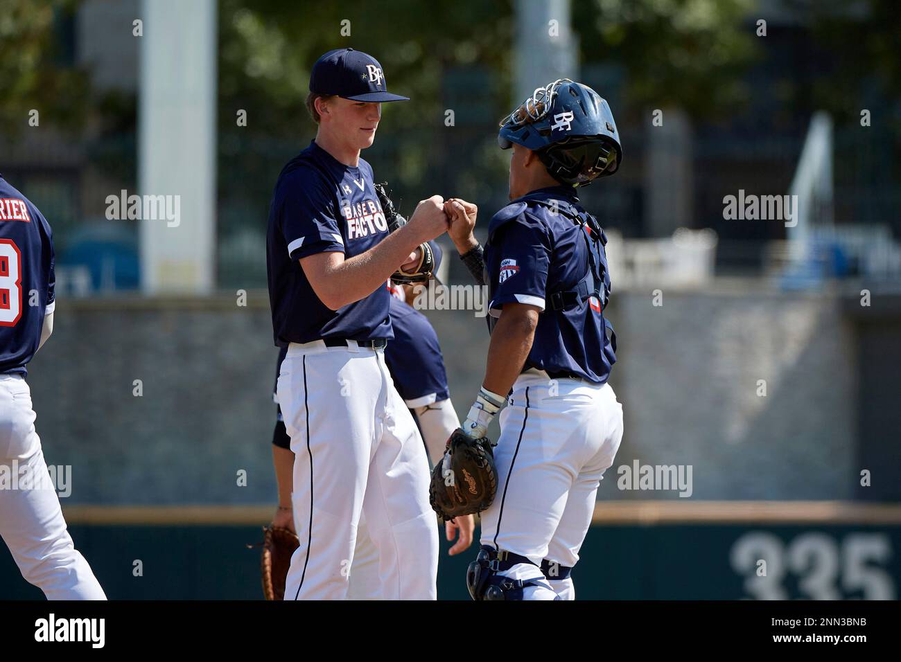 Catcher Harry Ford (1) fist bumps pitcher Thatcher Hurd (20) during the ...