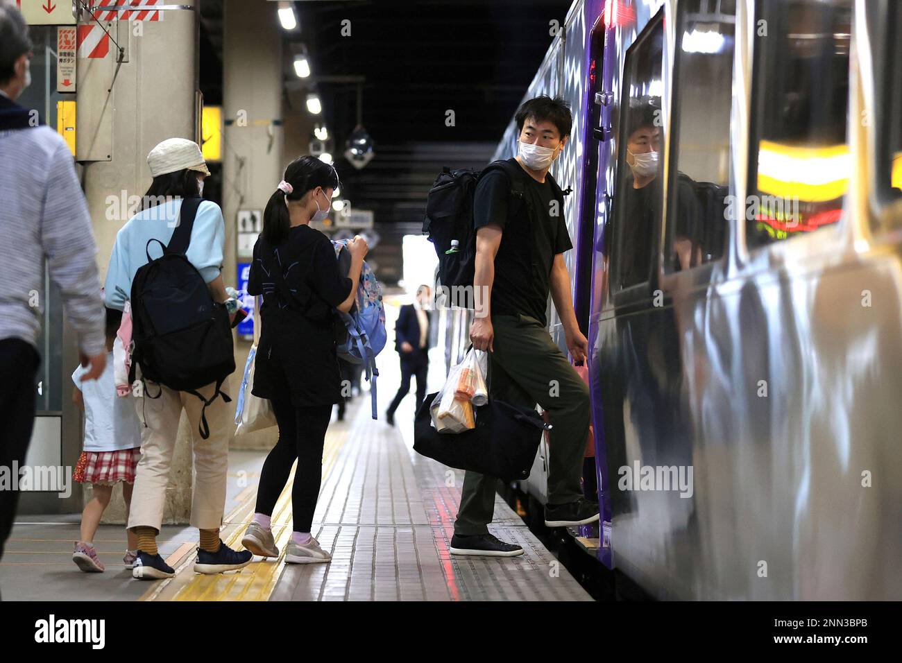 Passengers get on the Furano Lavender Express at JR Sapporo Station in Hokkaido on July10, 2021 ...