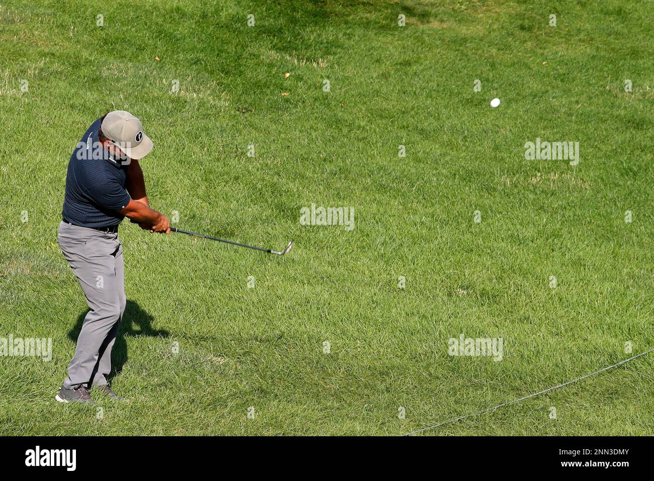 SILVIS, IL - JULY 09: PGA golfer Ryan Moore hits out of the rough on ...