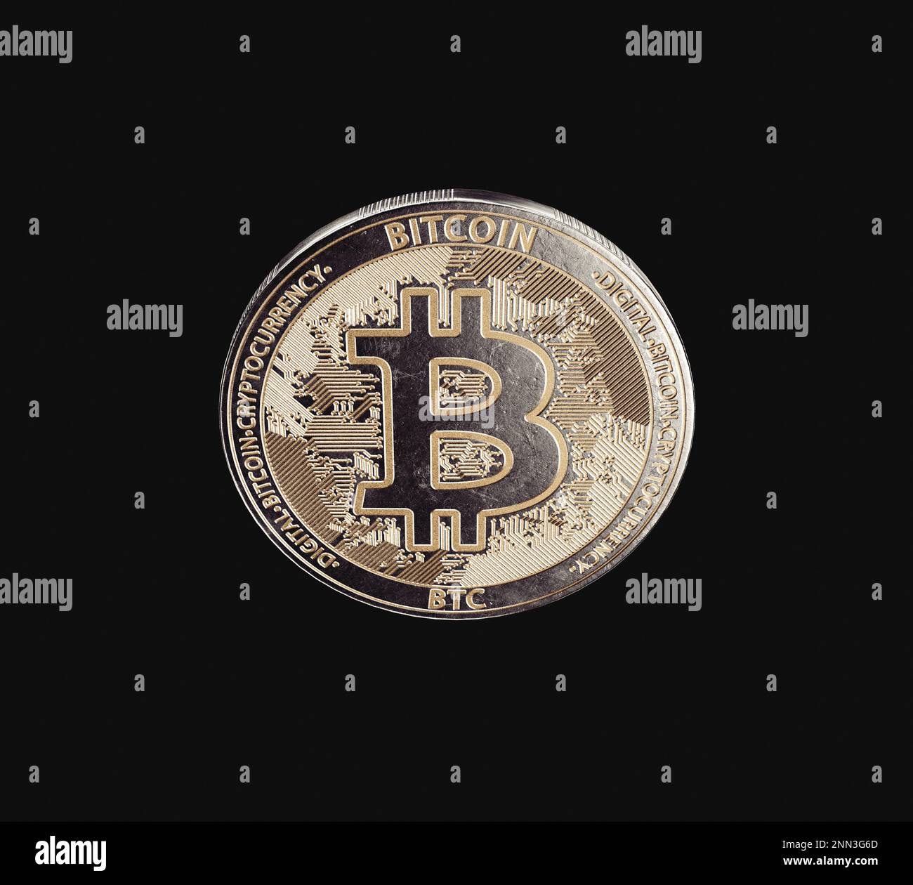 A dimly lit physical bitcoin cryptocurrency in bronze and silver coin ...