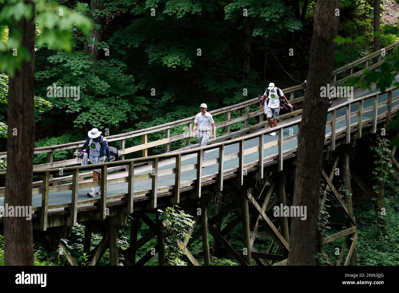 SILVIS, IL - JULY 08: PGA golfer J.T. Poston crosses a bridge to get to ...