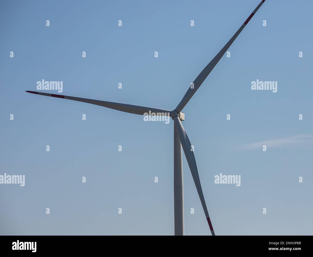 wind mill or also wind-turbine on wind farm in rotation to generate ...