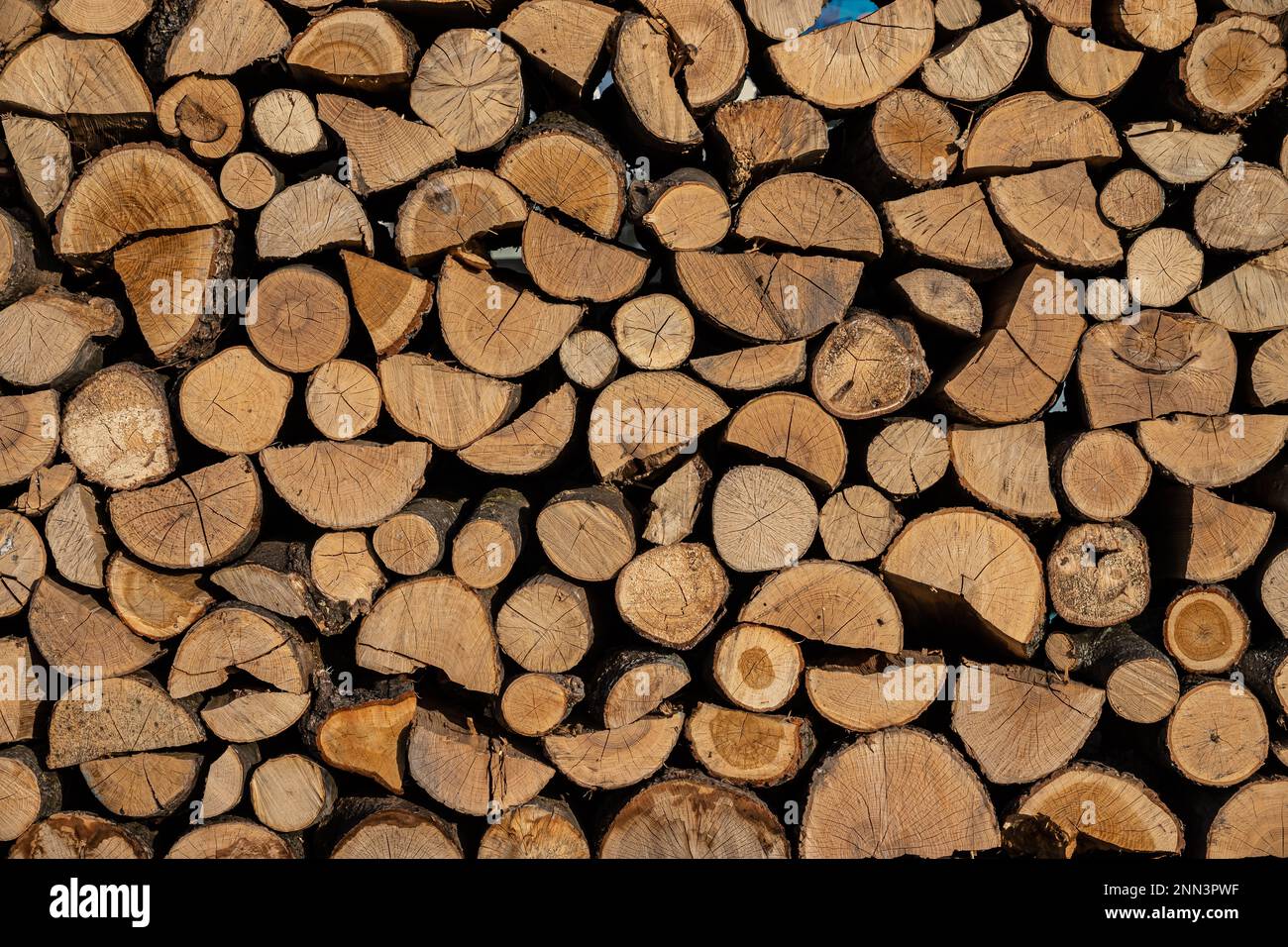 Pile of stacked triangle firewood prepared for fireplace and boiler ...