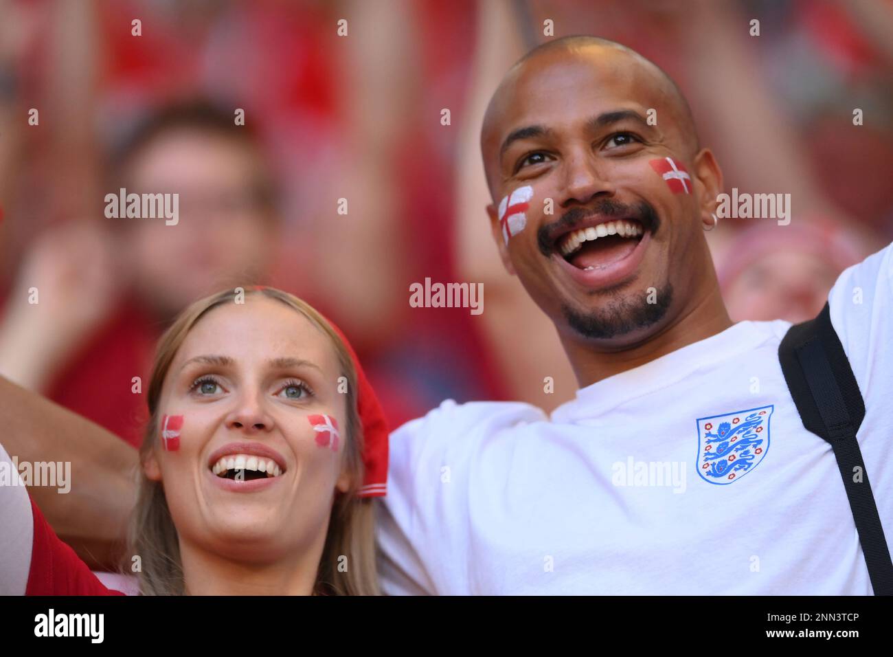 An England fan, right, poses for a photograph with a Denmark fan during ...