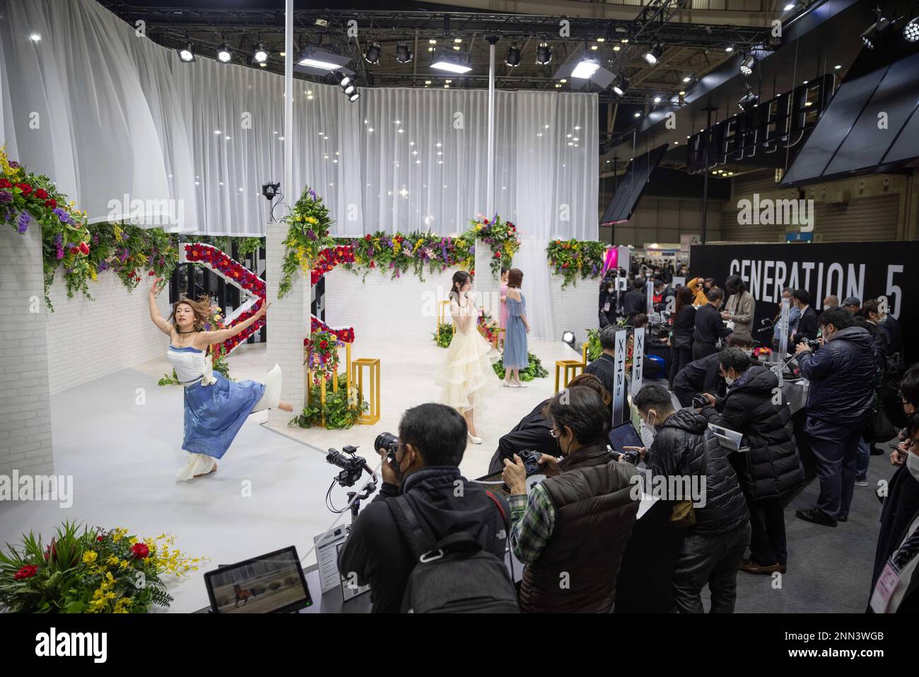 Yokohama, Japan. 24th Feb, 2023. Visitors take photos of dancing models ...