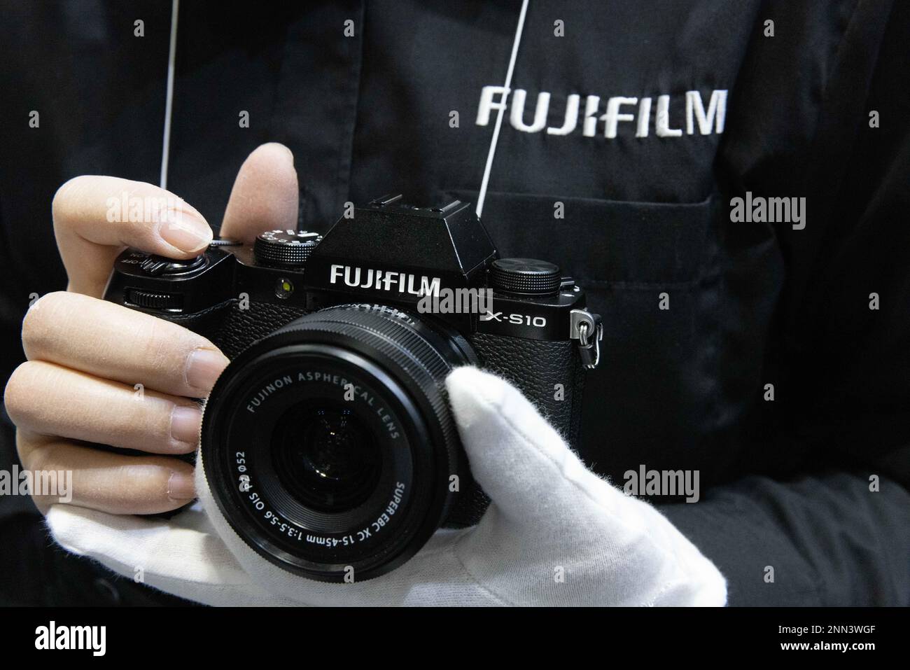 Yokohama, Japan. 24th Feb, 2023. FUJIFILM exhibitor holds the X-810 ...