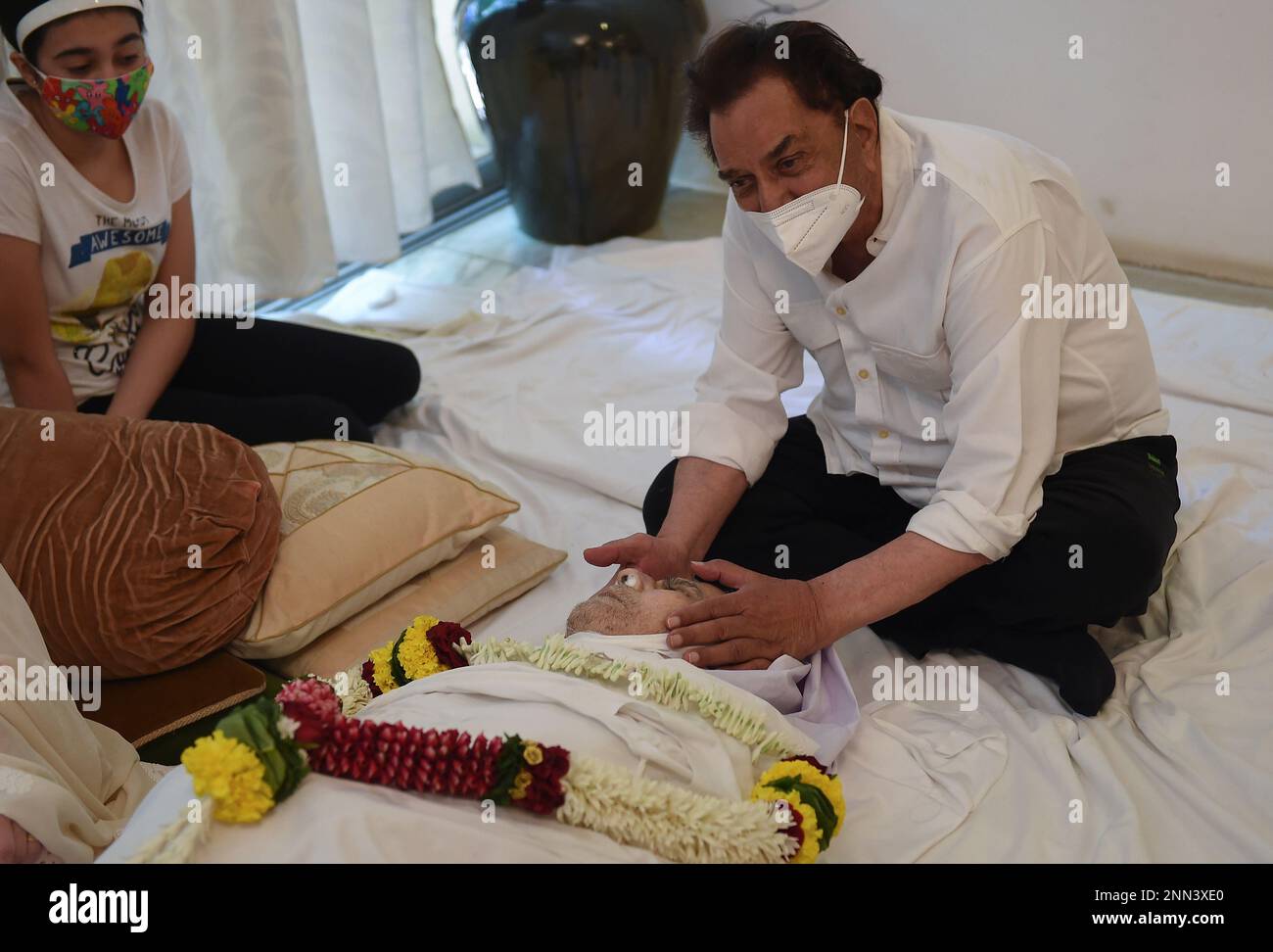 Actor Dharmendra, right, mourns near the body of Bollywood icon Dilip Kumar in Mumbai, India ...