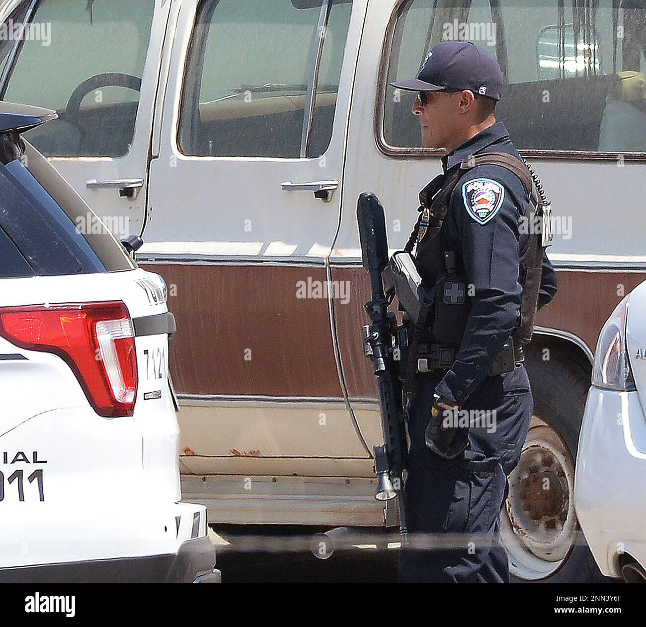 A Yuma Police Department officer is positioned on the backside of a ...