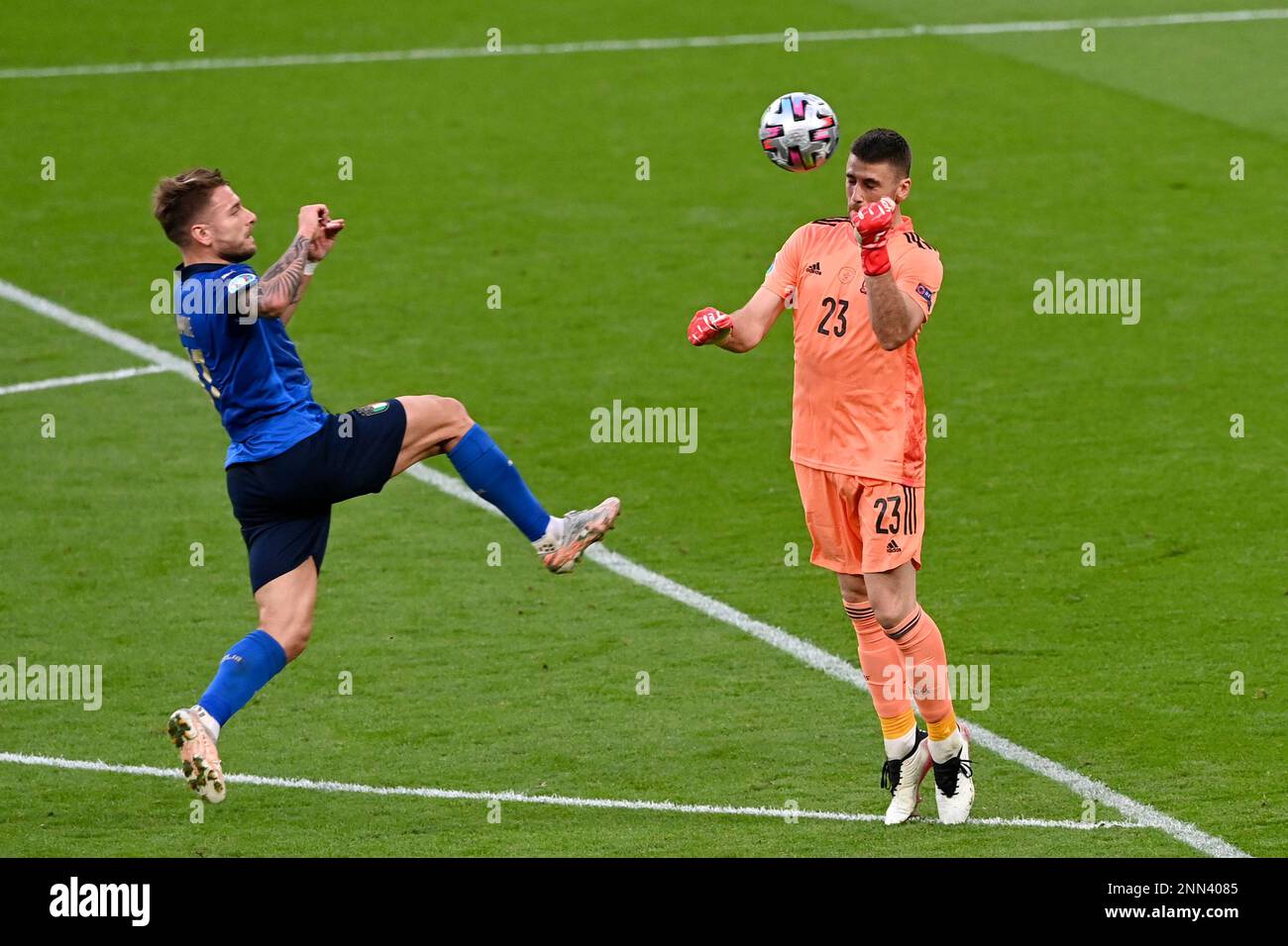 Spain's goalkeeper Unai Simon heads the ball in front of Italy's Ciro ...