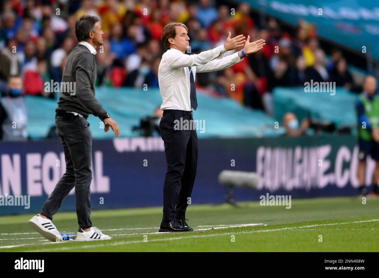 Spain's manager Luis Enrique, left, and Italy's manager Roberto Mancini ...