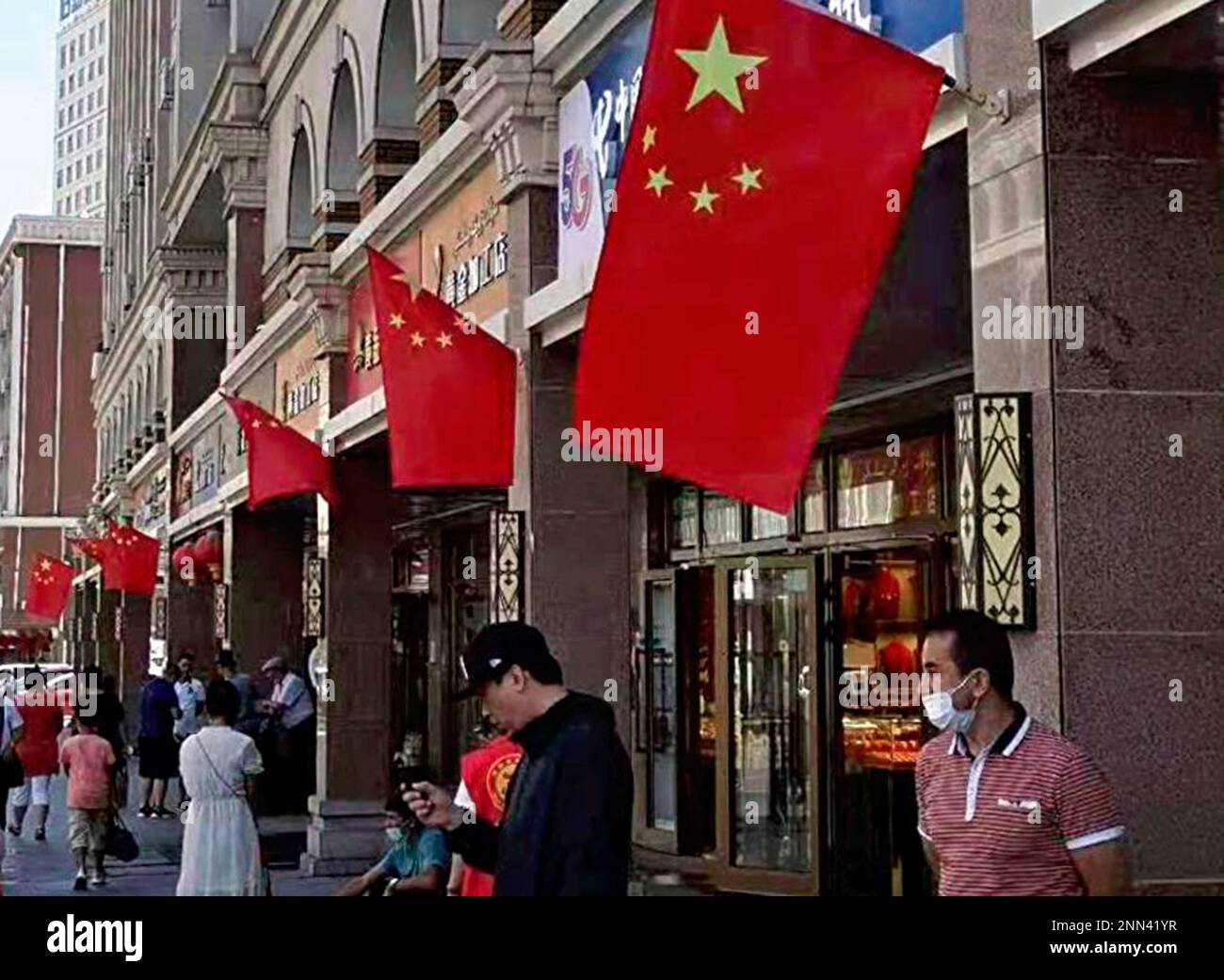 Chinese national flags are displayed at a commercial facility in Urumqi ...