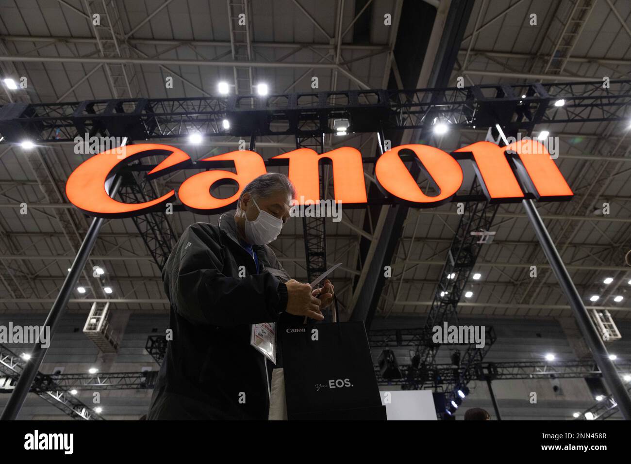 Visitor walks by Canon's exhibition area at the CP+2023 in Pacifico ... Visitor walks by Canon's exhibition area at the CP+2023 in Pacifico ...