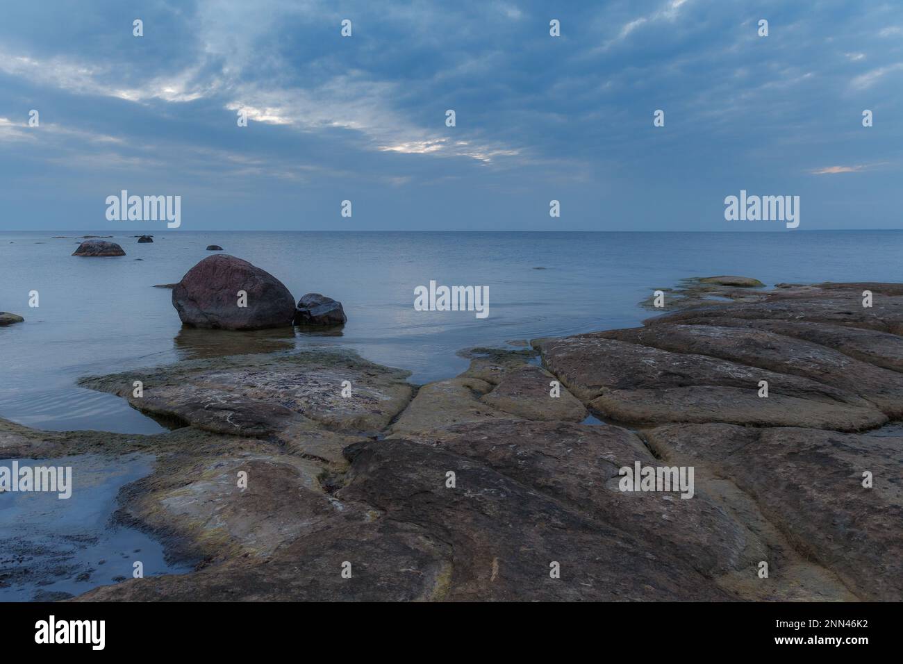 Beautiful sea shore view with with moss-covered rocks. Algae growing on ...
