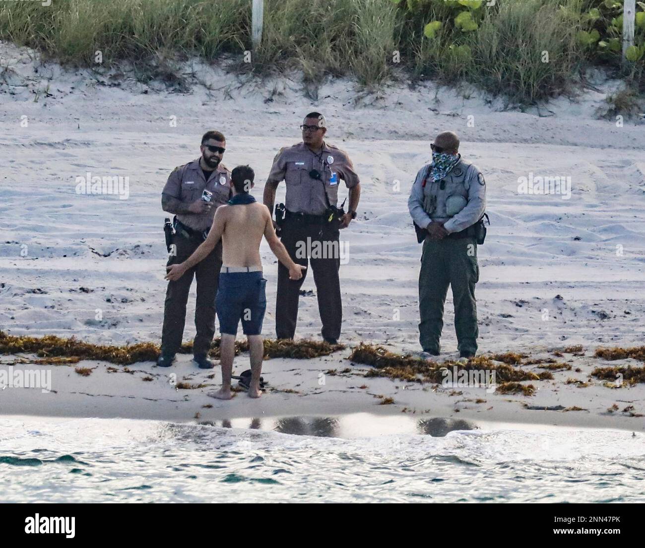 Police stop a man who crossed and walked several yards pass the ...