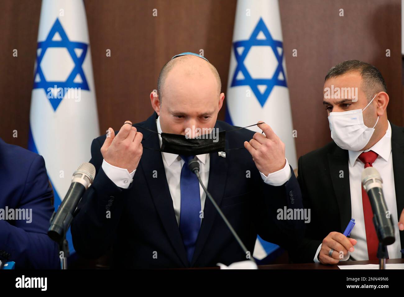 Israeli Prime Minister Naftali Bennett wears a face mask as he attends ...