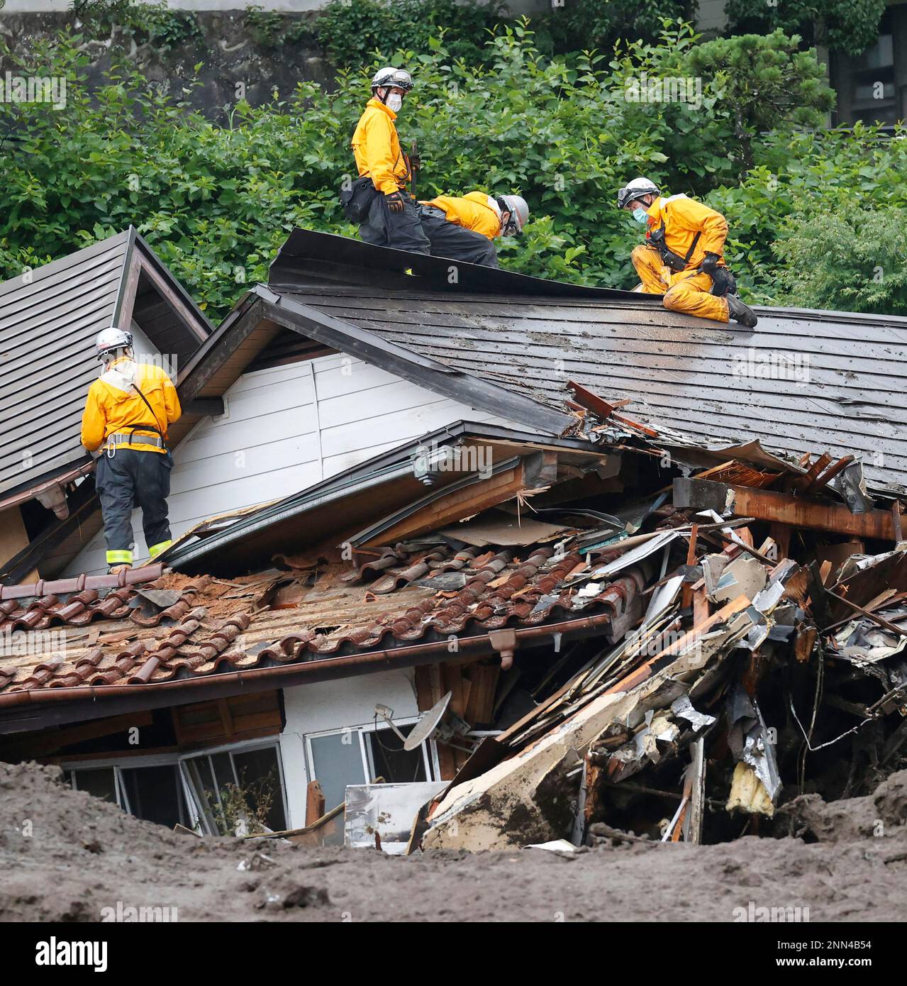 Rescuers conduct a search operation at the site of a mudslide at Izusan ...