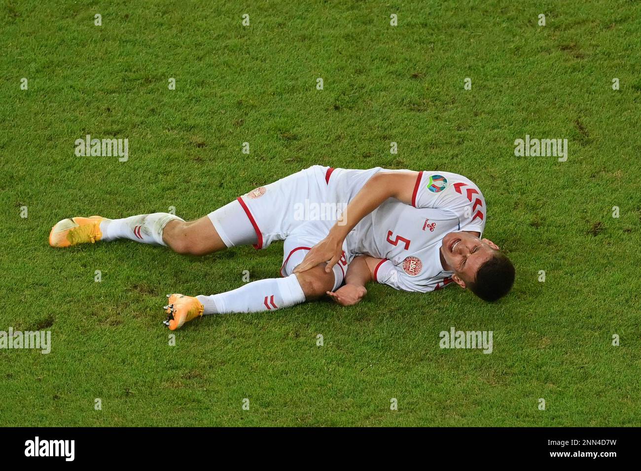 Denmark's Joakim Maehle lies injured during the Euro 2020 soccer ...