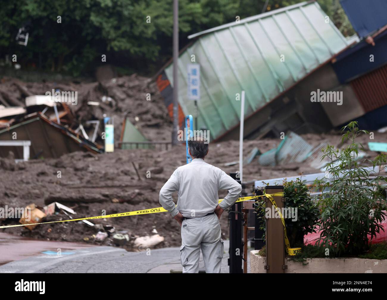 Housese are swamped with a mudslide at Izuyama district, Atami ...
