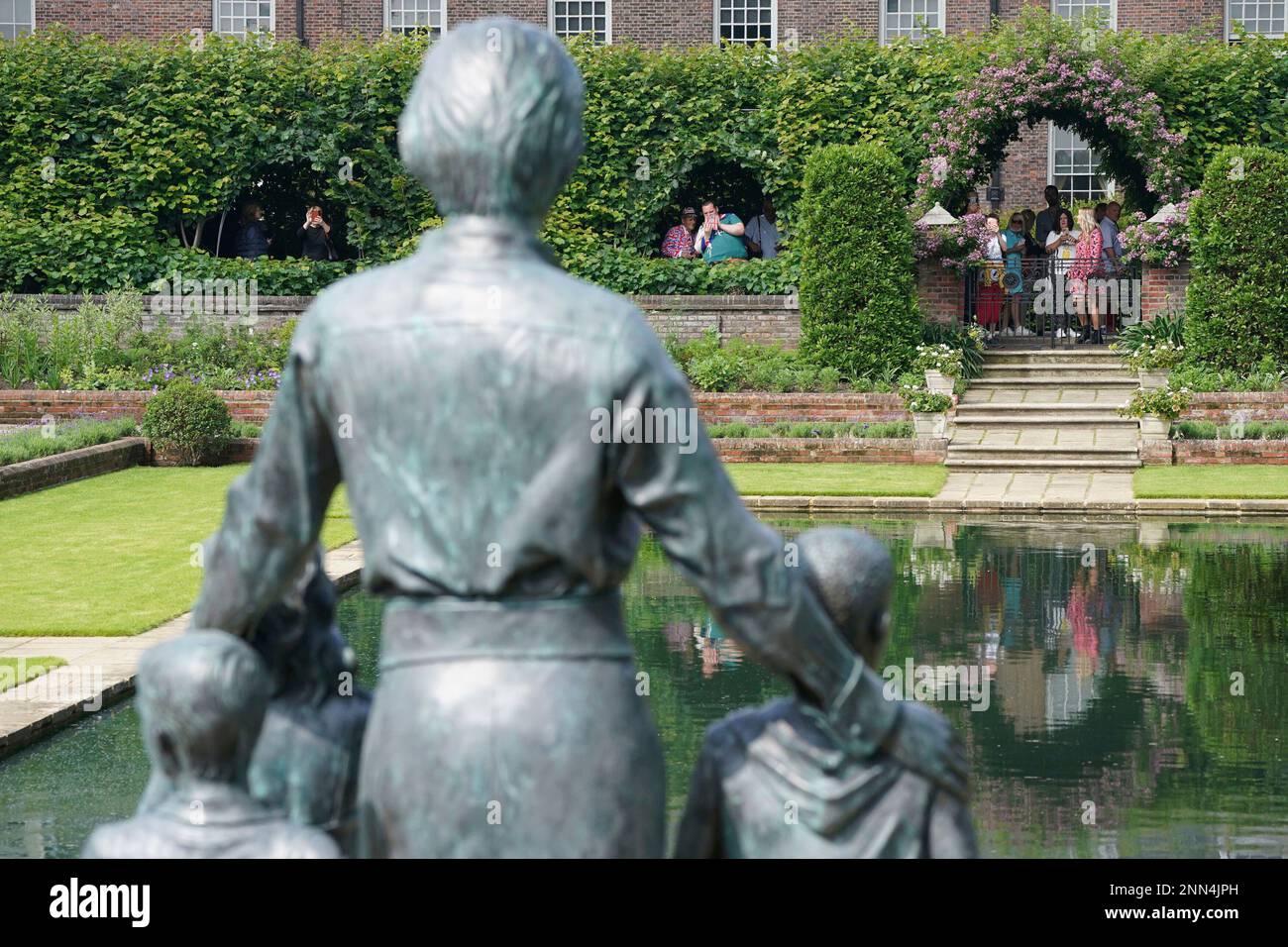 Members of the public view the statue of Diana, Princess of Wales, a ...