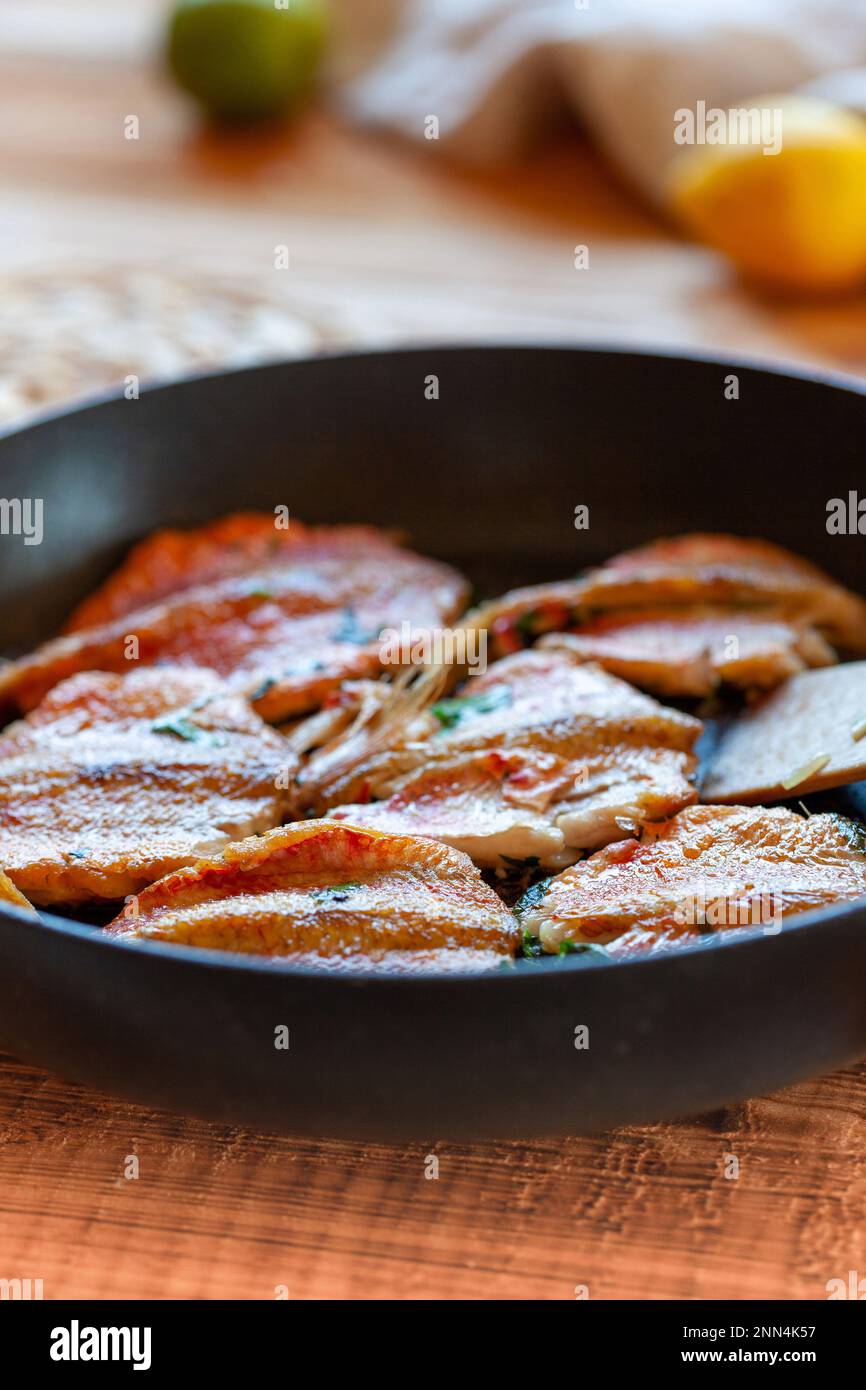red mullet fish cooked on a pan, side view, selective focus Stock Photo ...