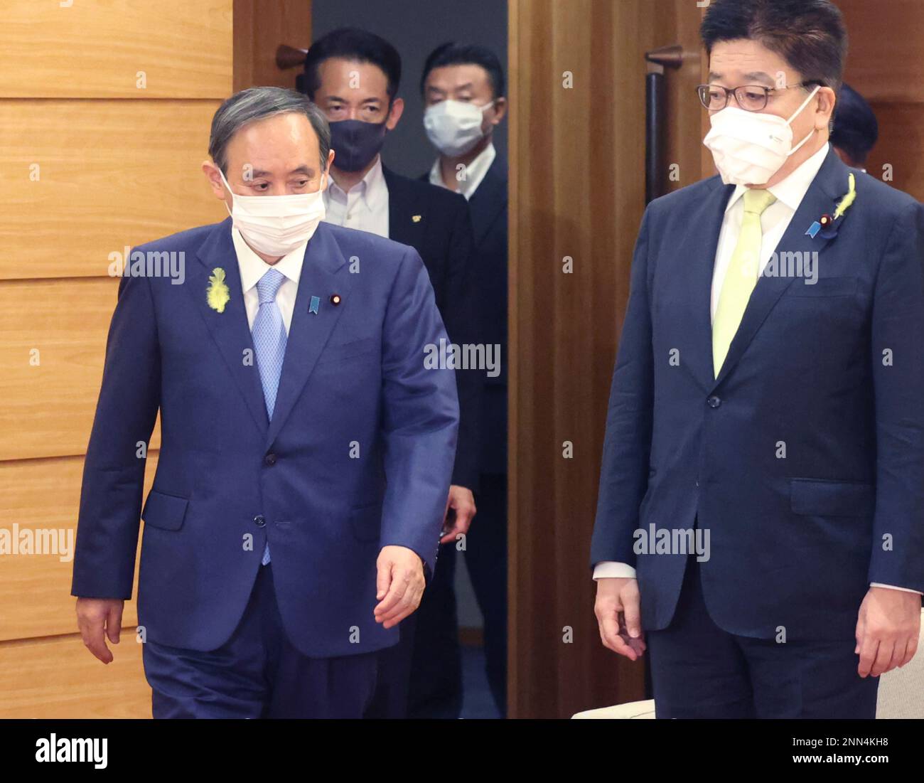 Japan's Prime Minister Yoshihide Suga (L) attends a cabinet meeting at ...