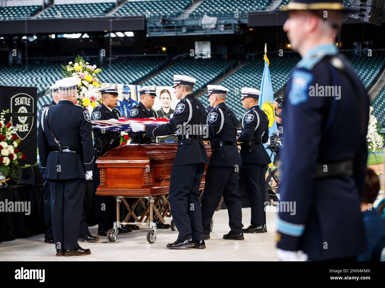 Seattle police officers fold the United States flag to present to the ...