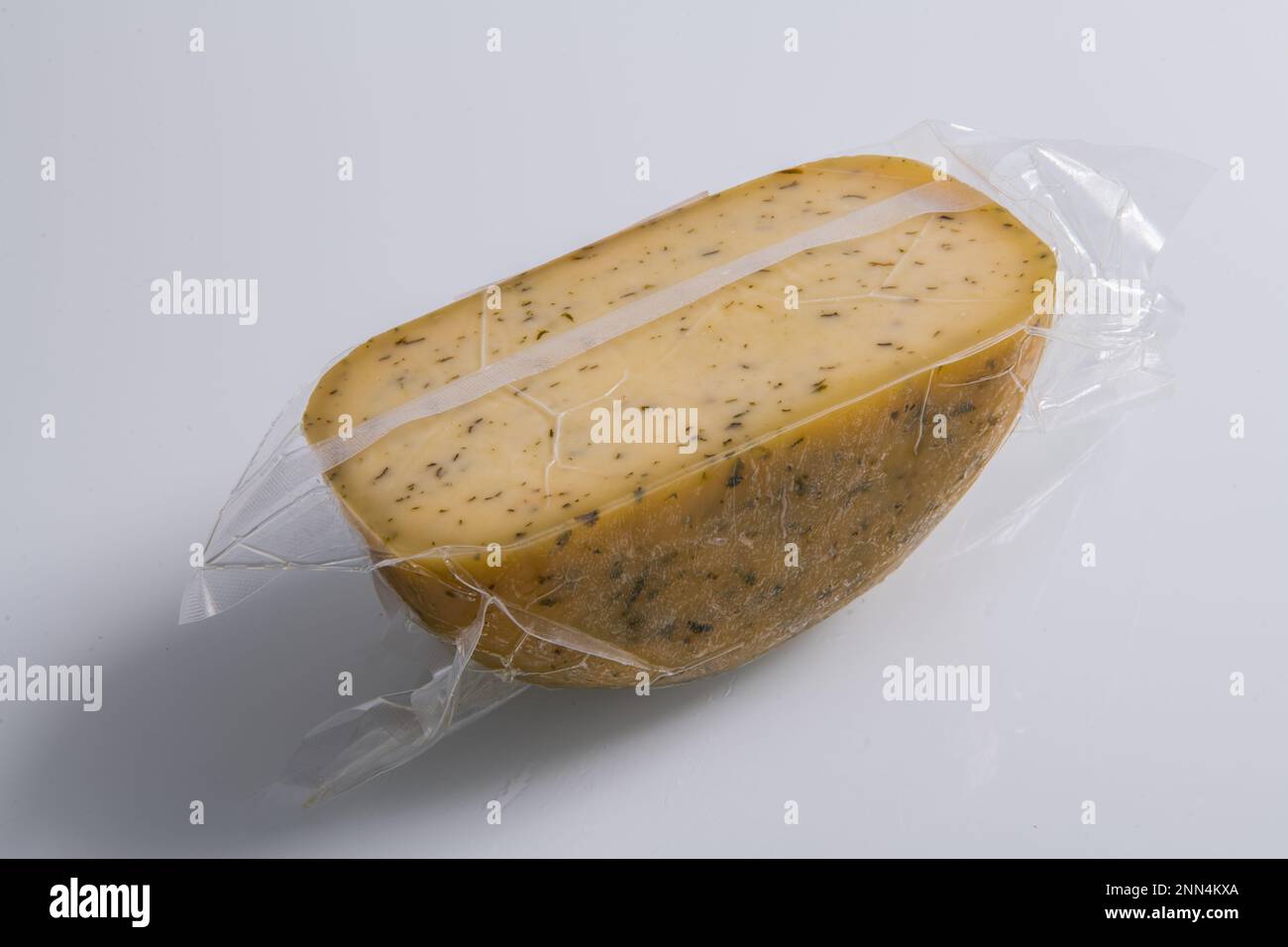 A piece of homemade vacuumed traditional Bosnian cheese isolated on a ...