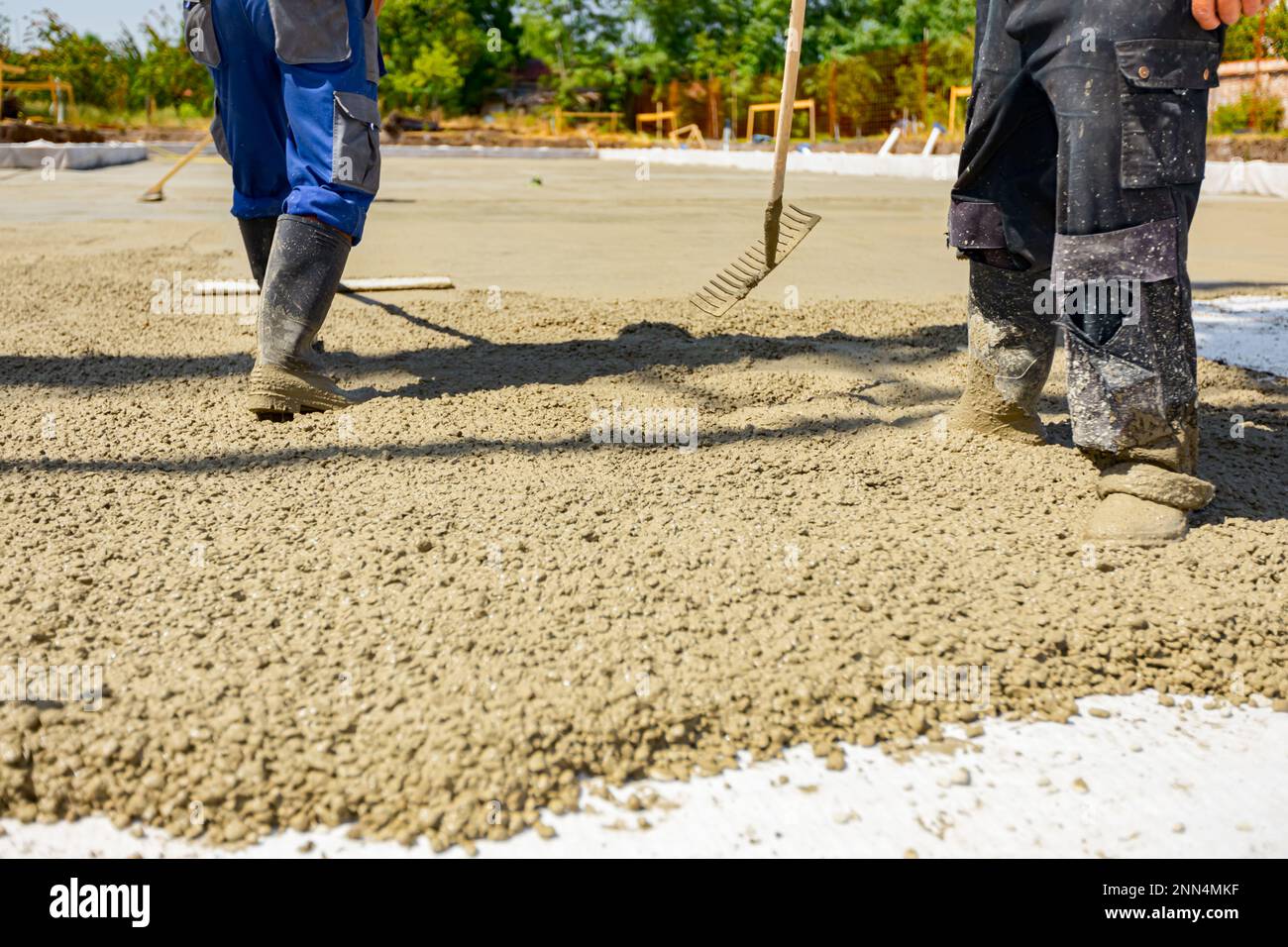 Construction workers, riggers are using rake and wooden handmade ...