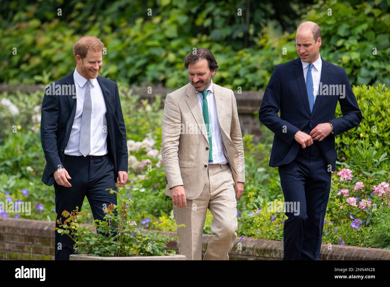 Britain's Prince William, right, and Prince Harry speak with garden ...