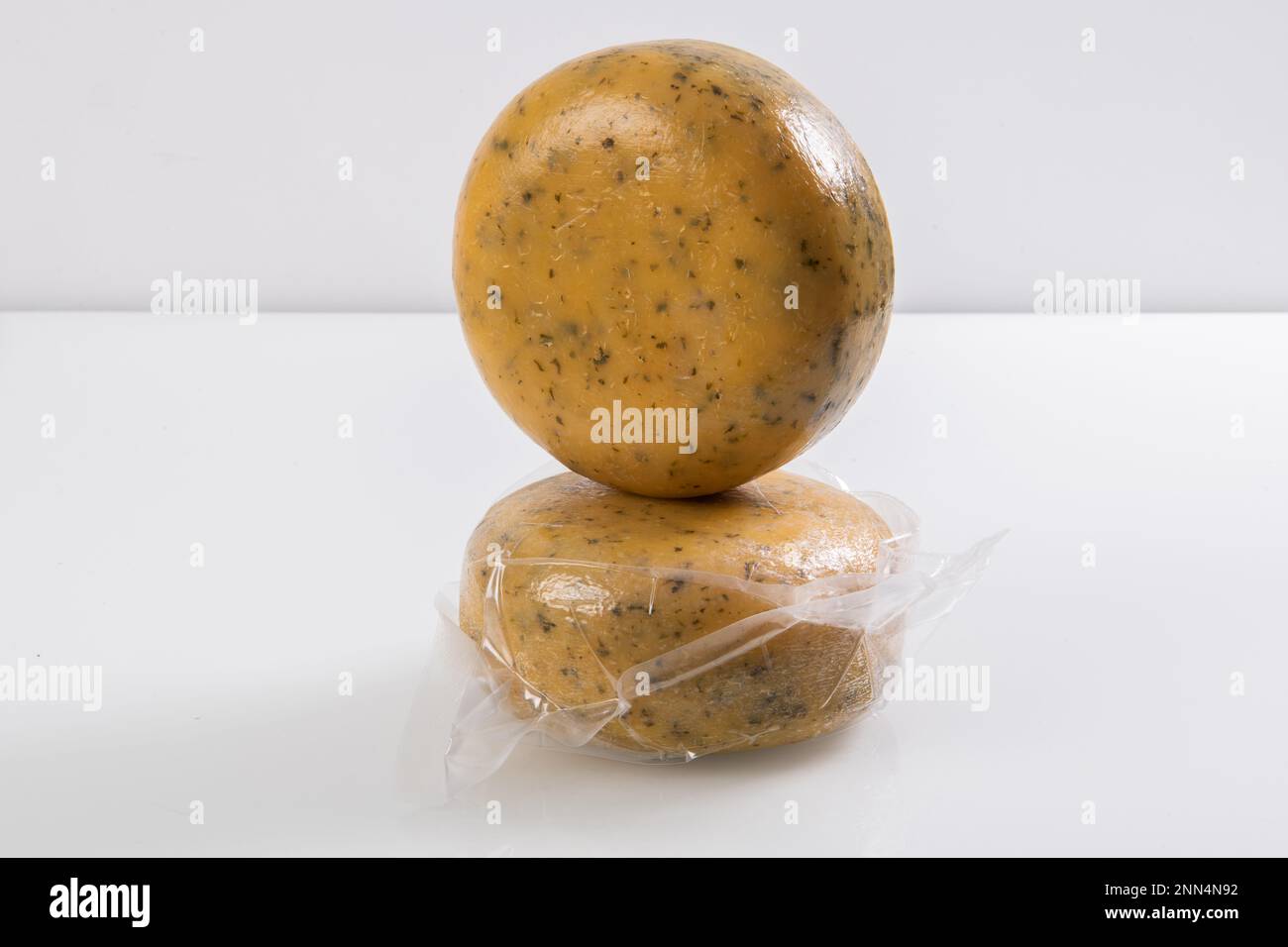 A piece of homemade vacuumed traditional Bosnian cheese isolated on a ...