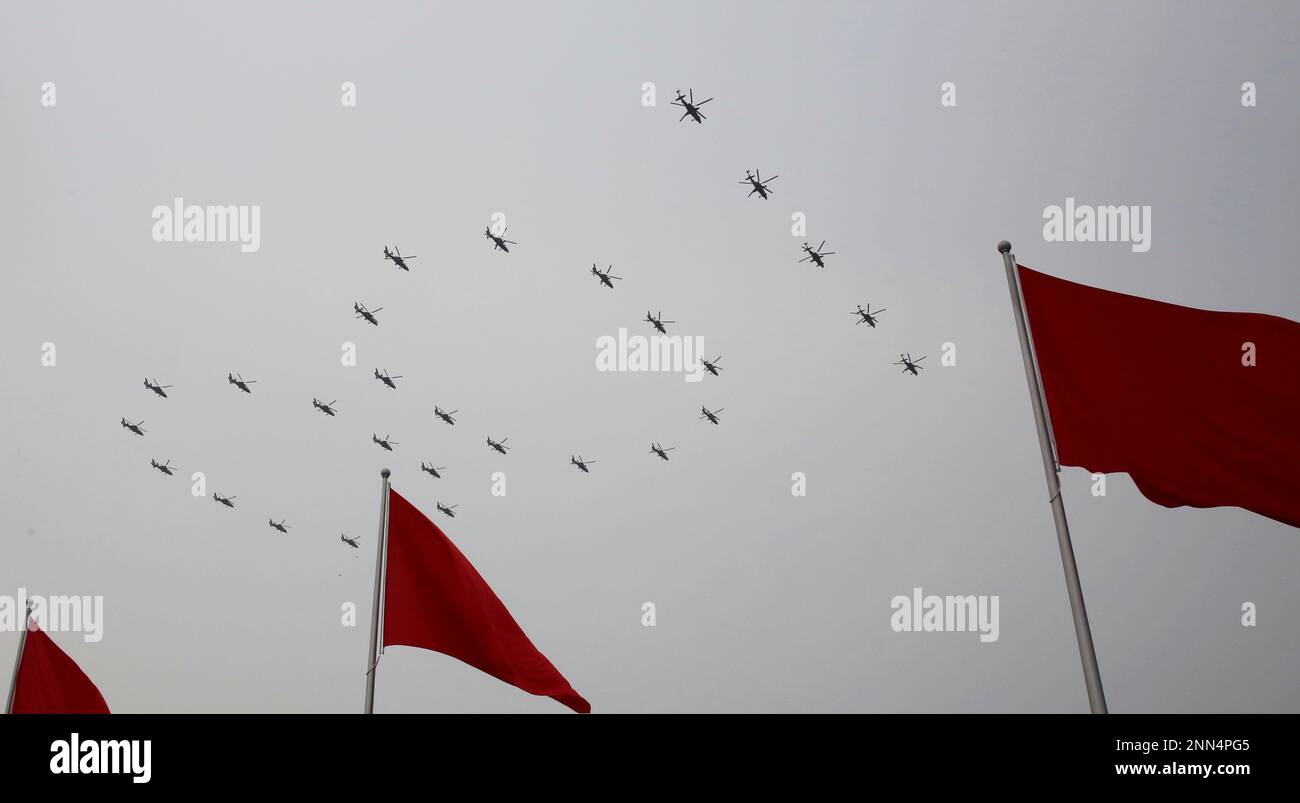 Helicopters fly over Tiananmen Square in the shape of "100" during a ...