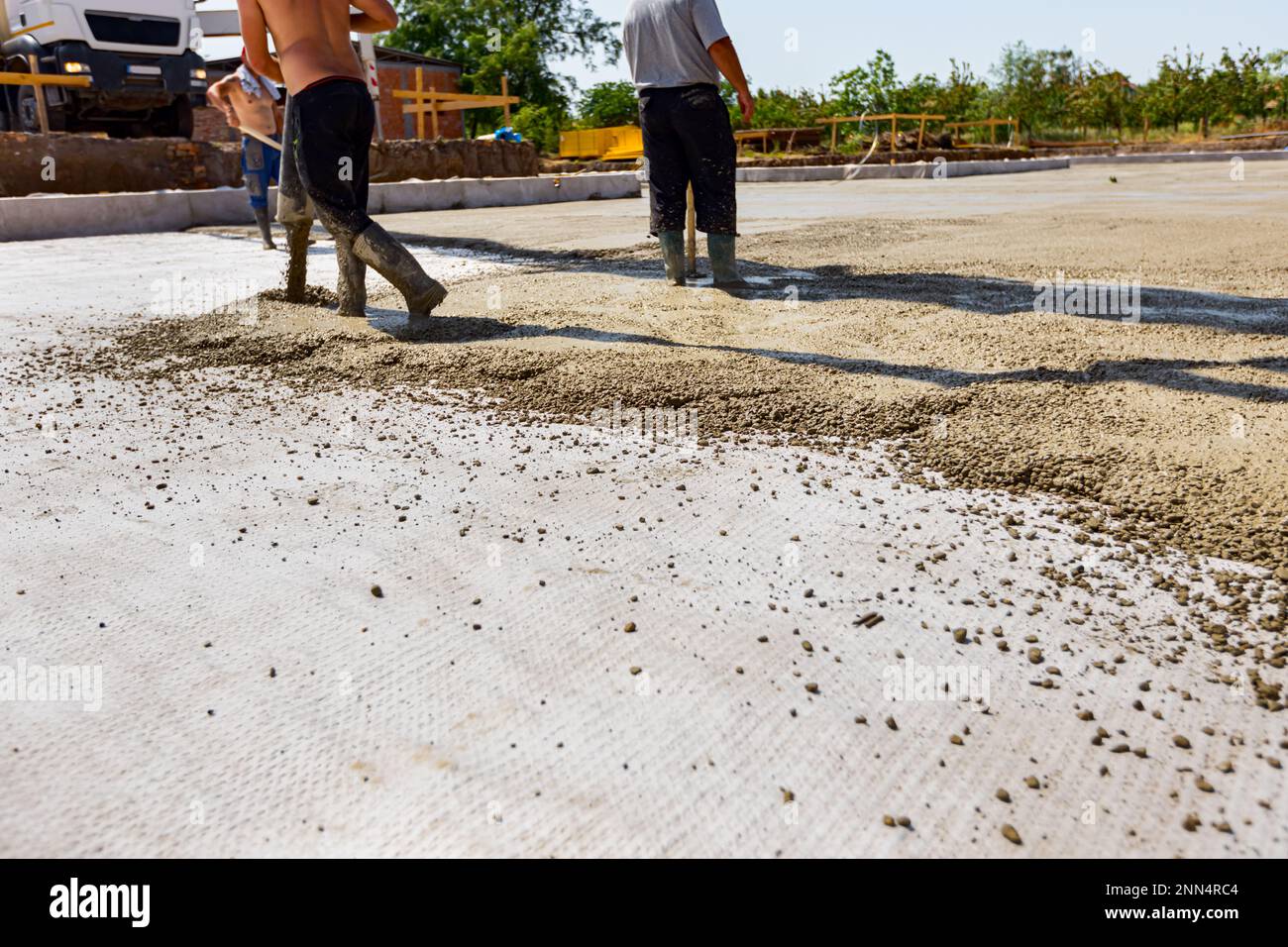 Construction worker is directing the pump tube on right direction ...