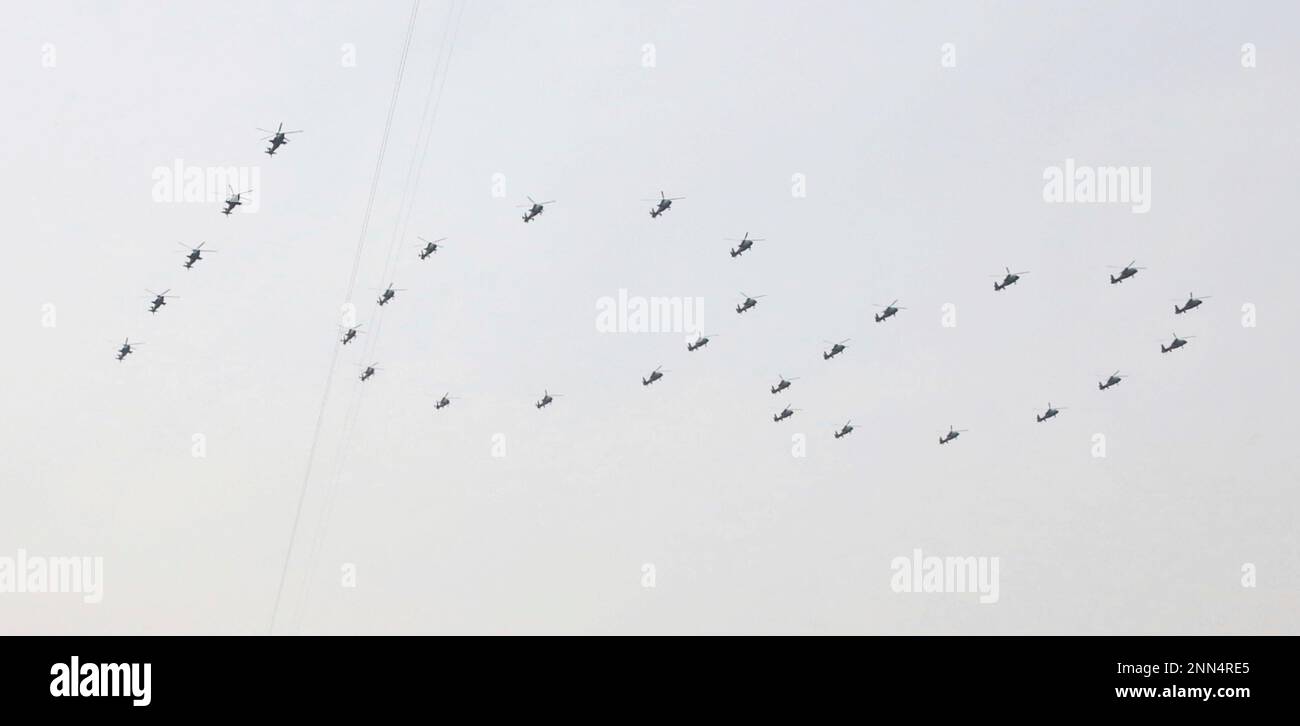 Helicopters fly over Tiananmen Square in the shape of "100" during a ...