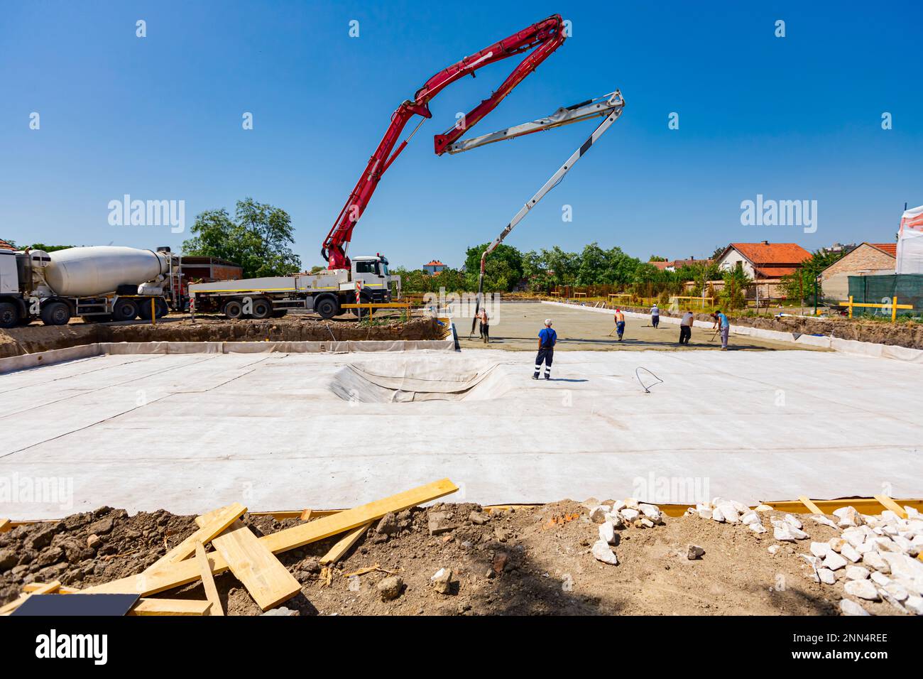 Construction site, mixer truck pouring concrete into pump machine ...
