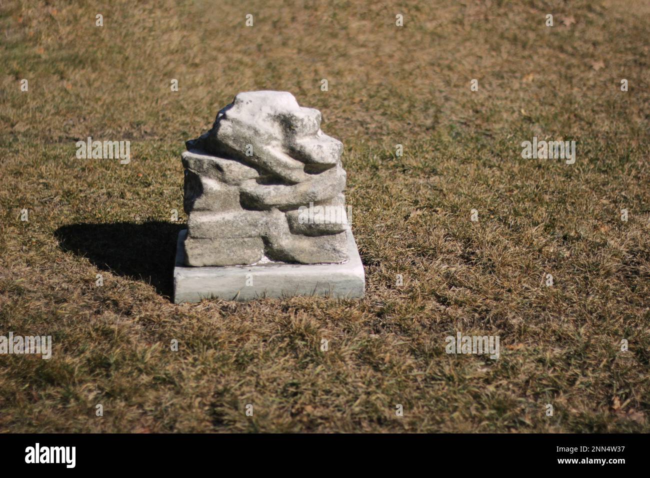 A vintage natural stone tombstone with a pike of stones and rocks Stock ...