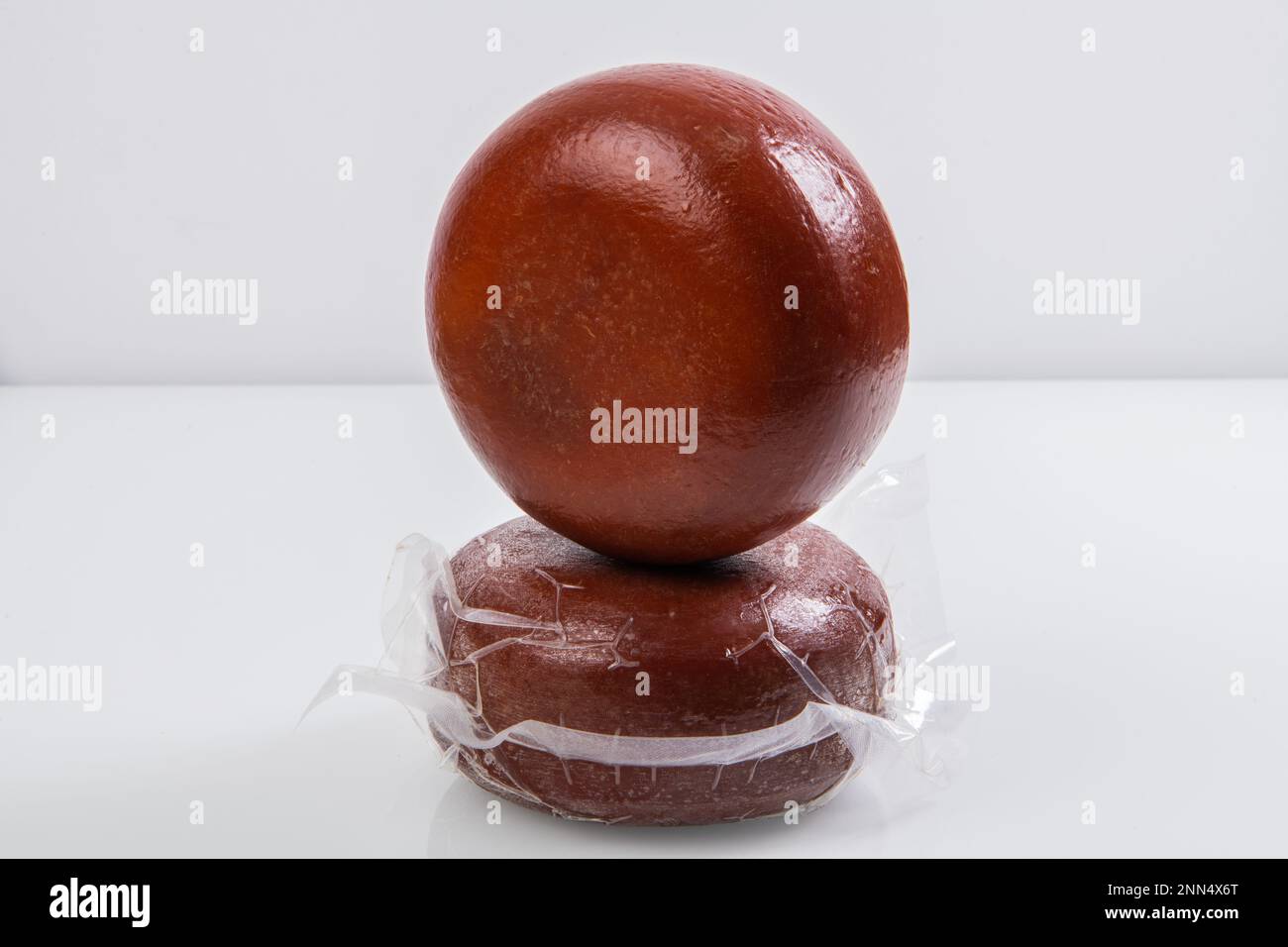 A piece of homemade vacuumed traditional Bosnian cheese isolated on a ...