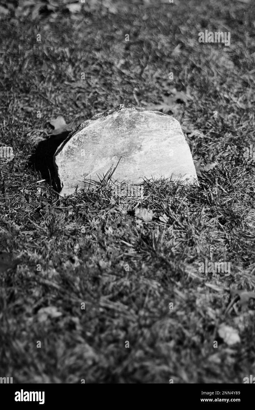 A worn and weathered old tombstone with a blank epitaph and room for ...