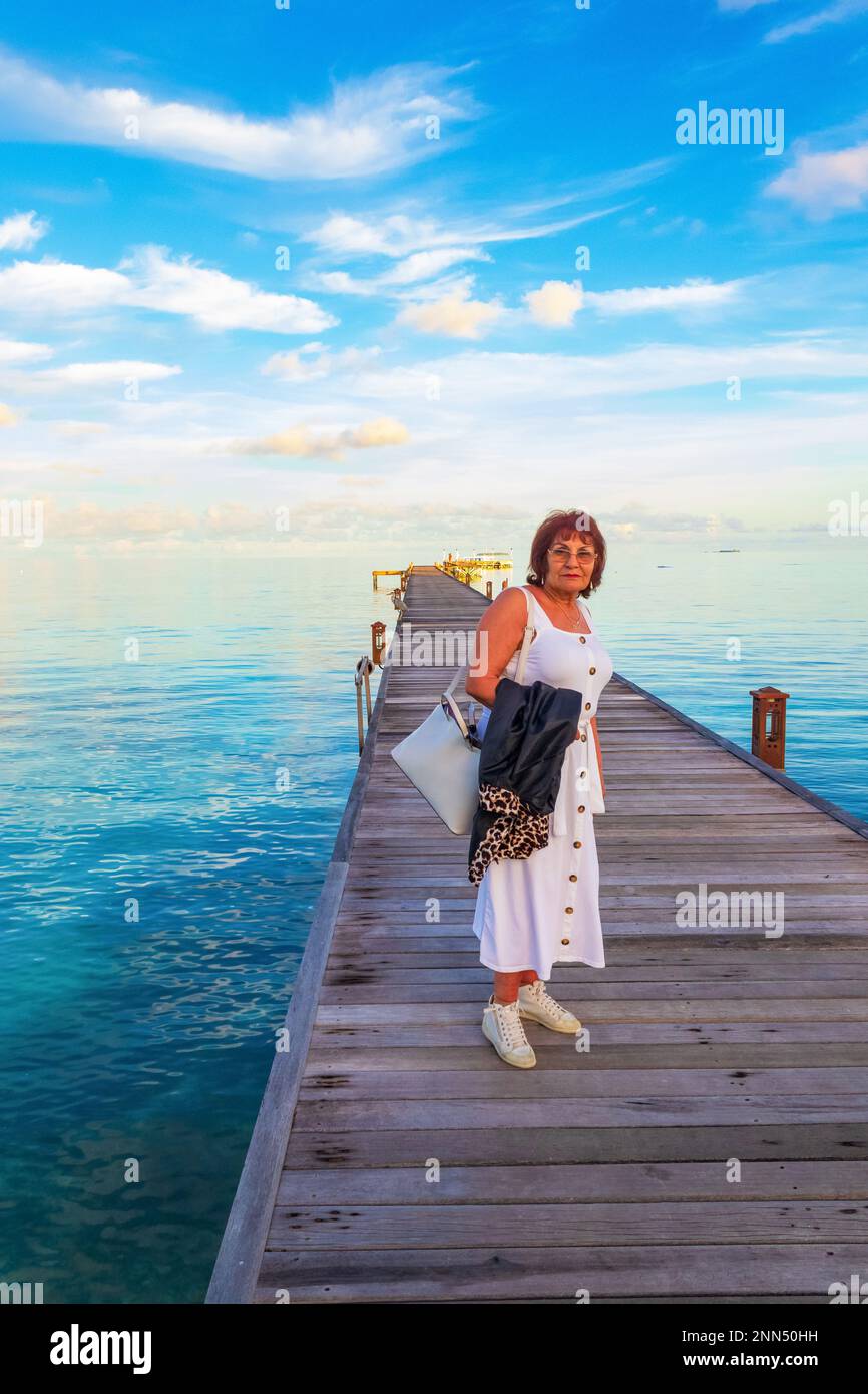 Elegant senior 72 years old woman Maria in white dress ready for her ...