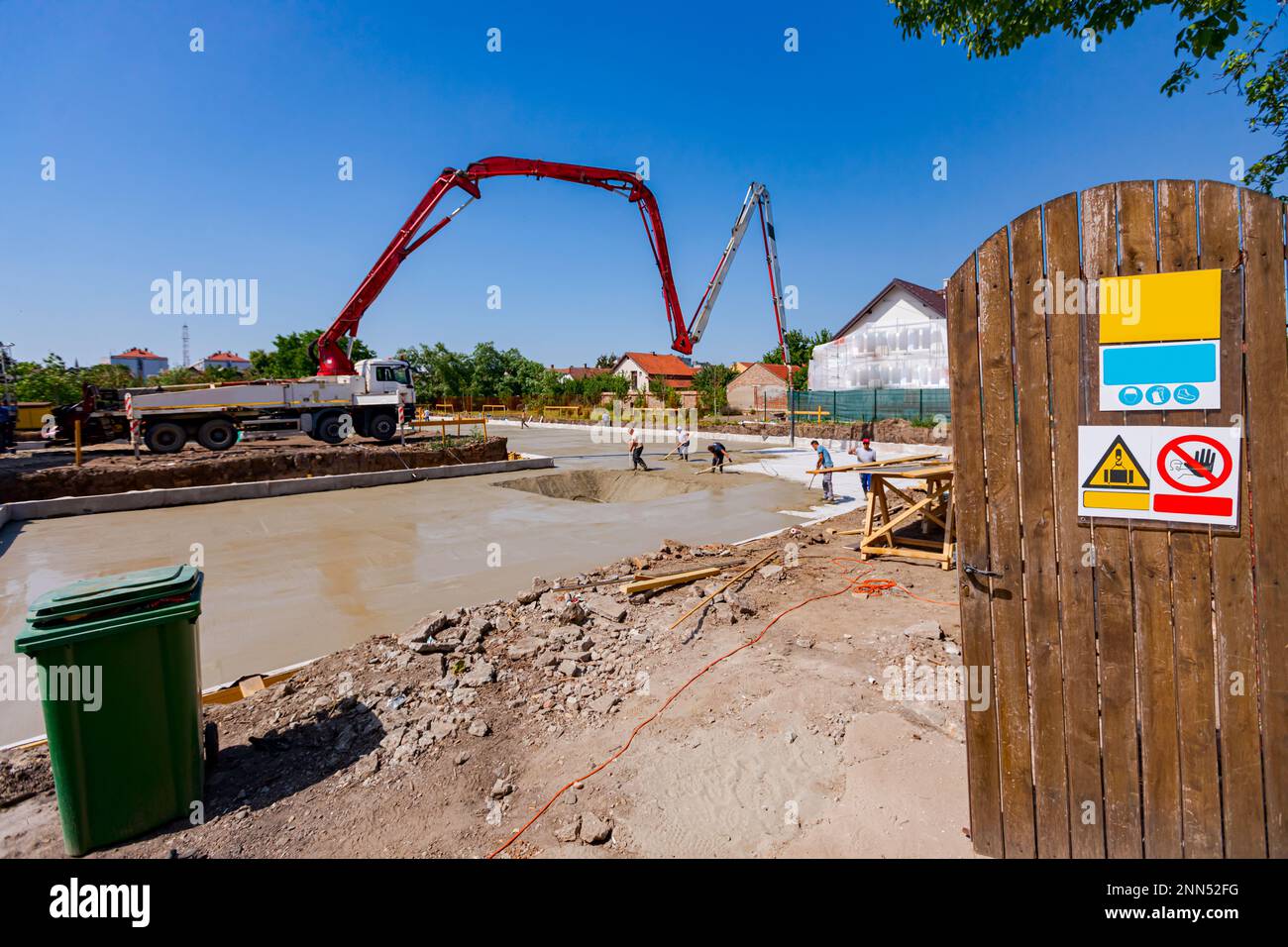 Open door made of wooden planks with warning signs on it, site entrance ...