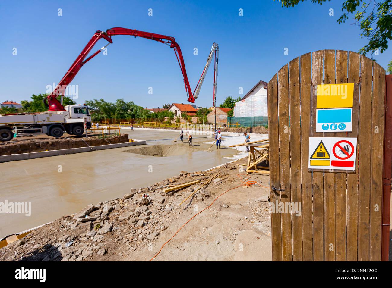 Open door made of wooden planks with warning signs on it, site entrance ...