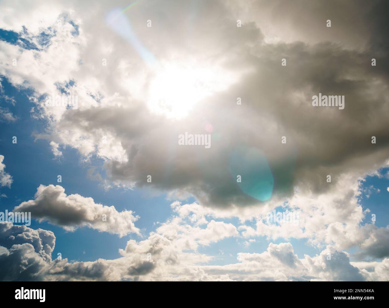 Sun and dramatic white clouds Stock Photo - Alamy